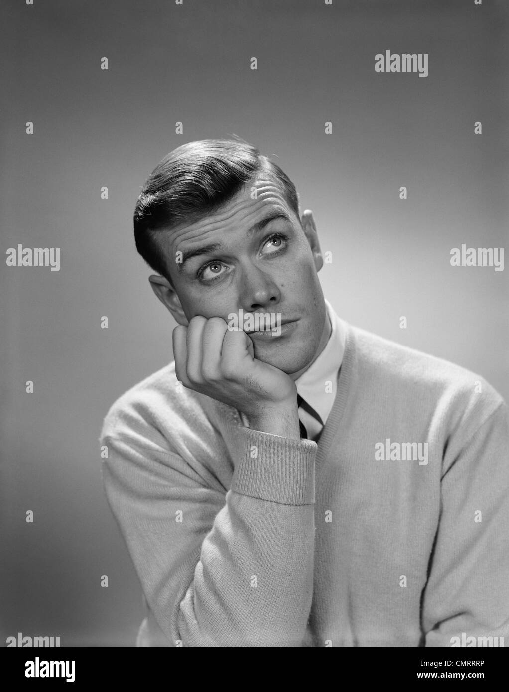 1960s YOUNG MAN HAND TO CHEEK LOOKING UP QUIZZICAL WONDERING THOUGHTFUL ...