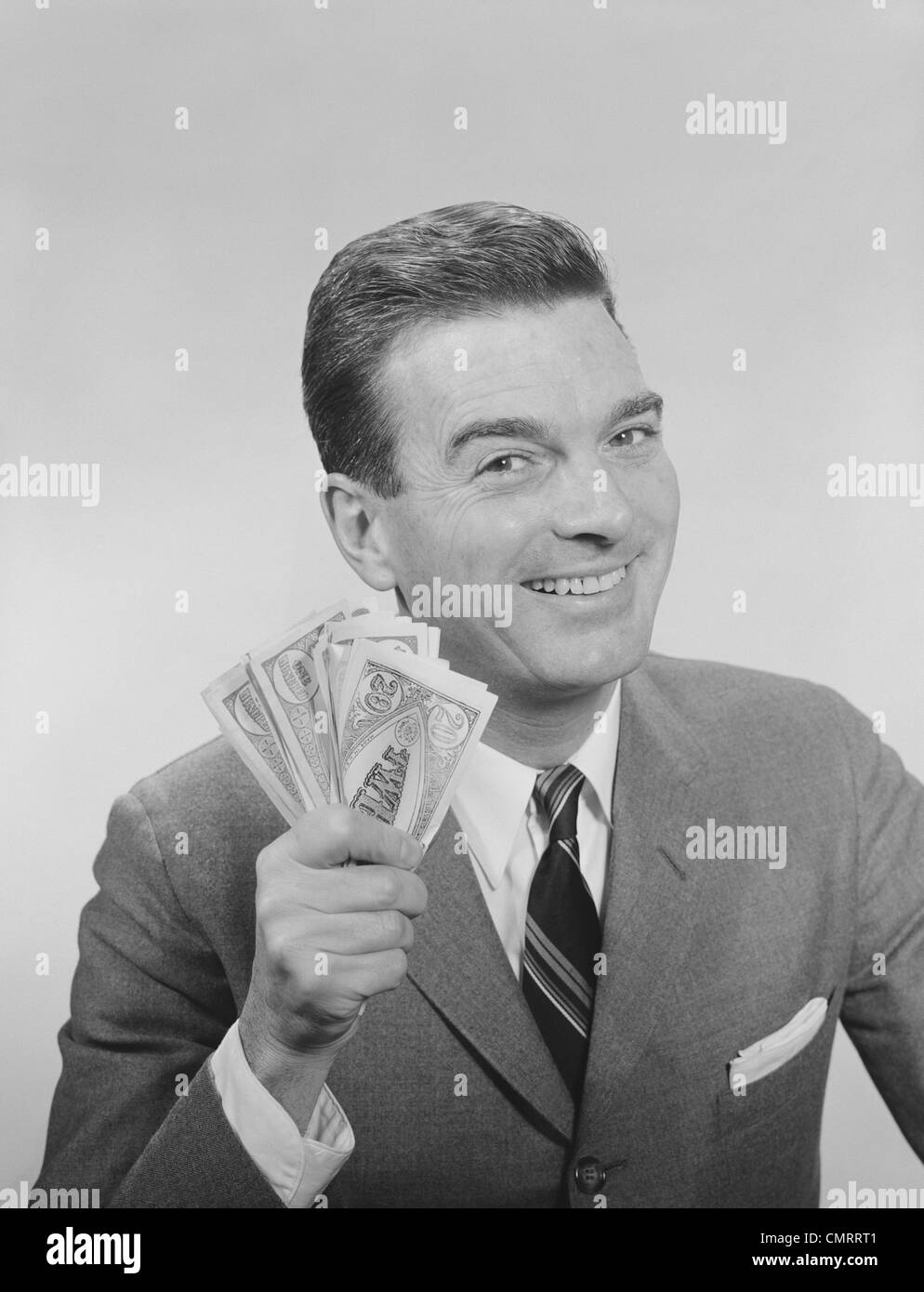 1950s 1960s SMILING MAN HOLDING A FISTFUL OF MONEY FAKE BILLS LOOKING ...