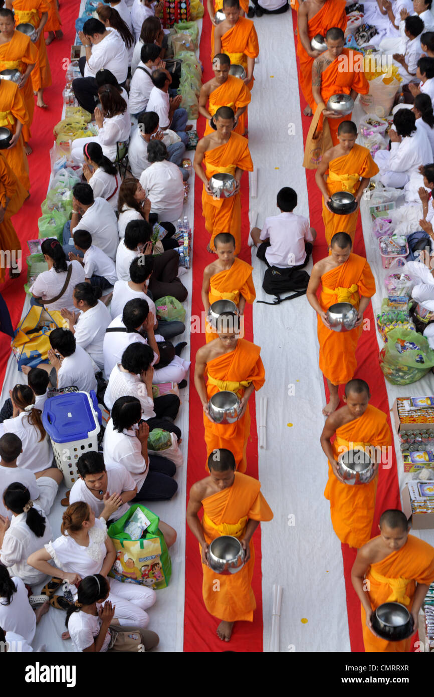 Thai people giving food offerings to Buddhist monks in Bangkok ...