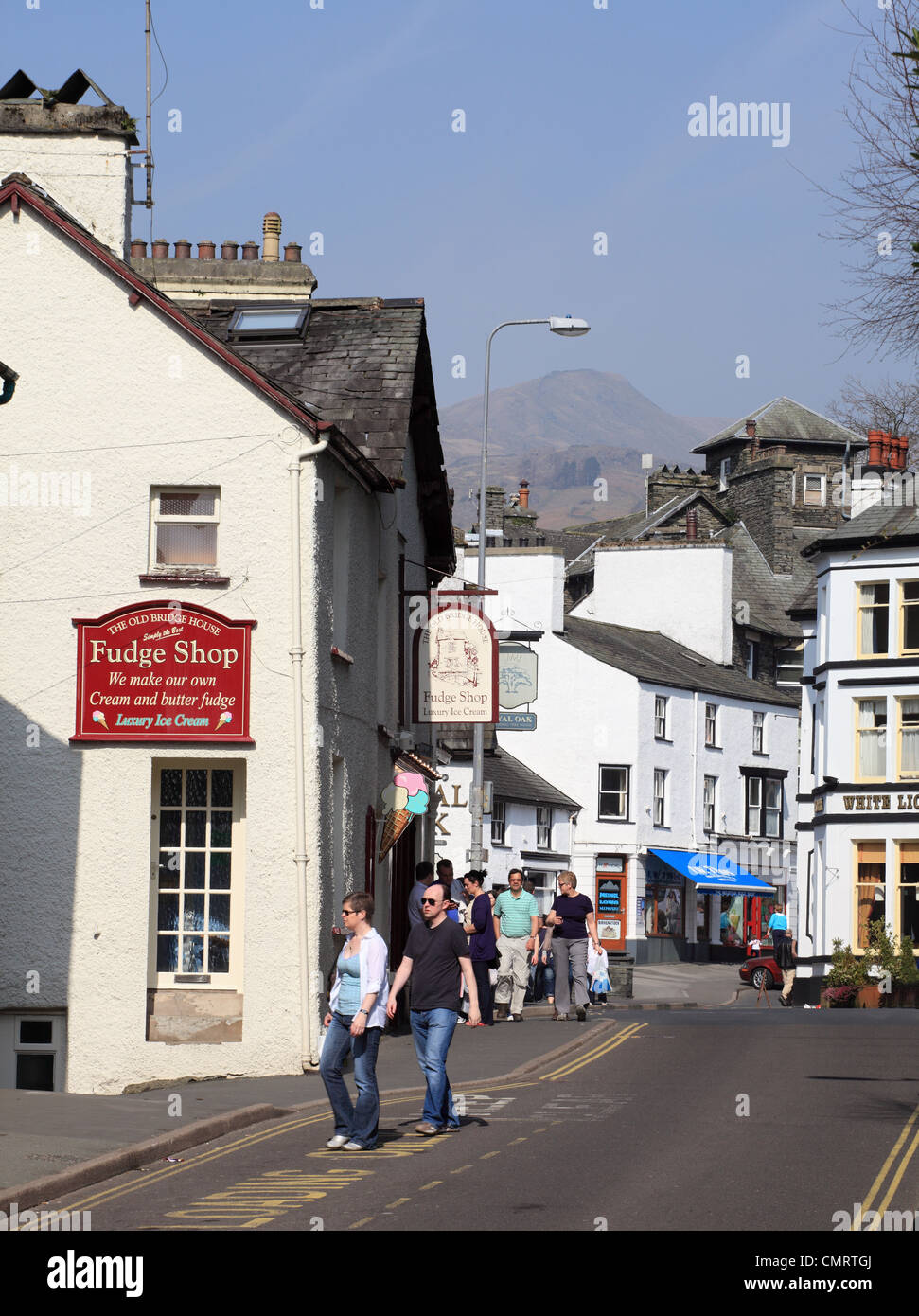 People walking down Lake Road past the Fudge Shop in Ambleside, Cumbria ...
