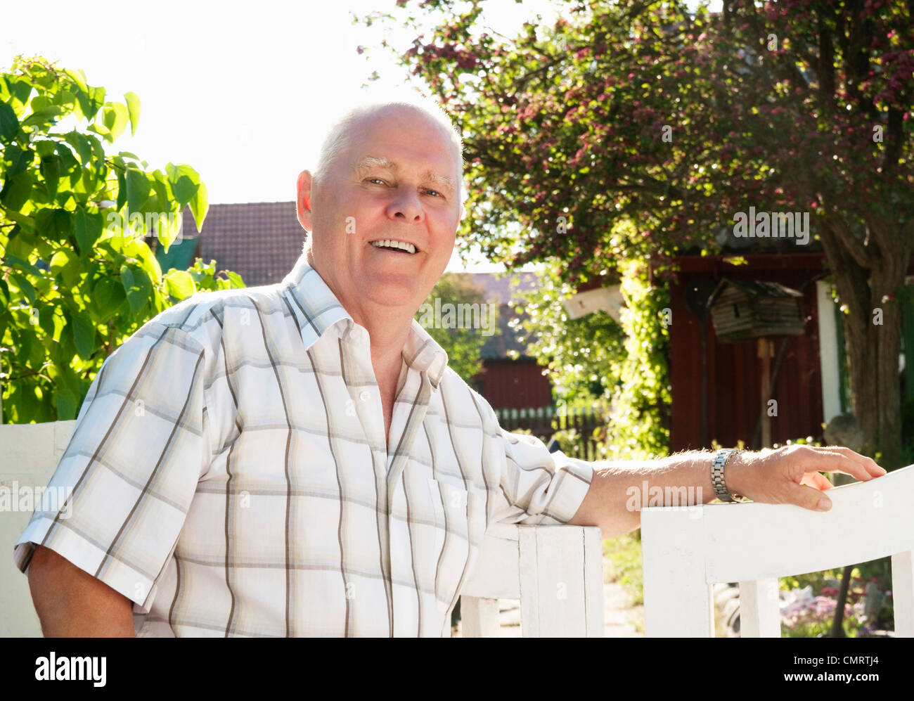 Happy elderly man standing outside Stock Photo - Alamy