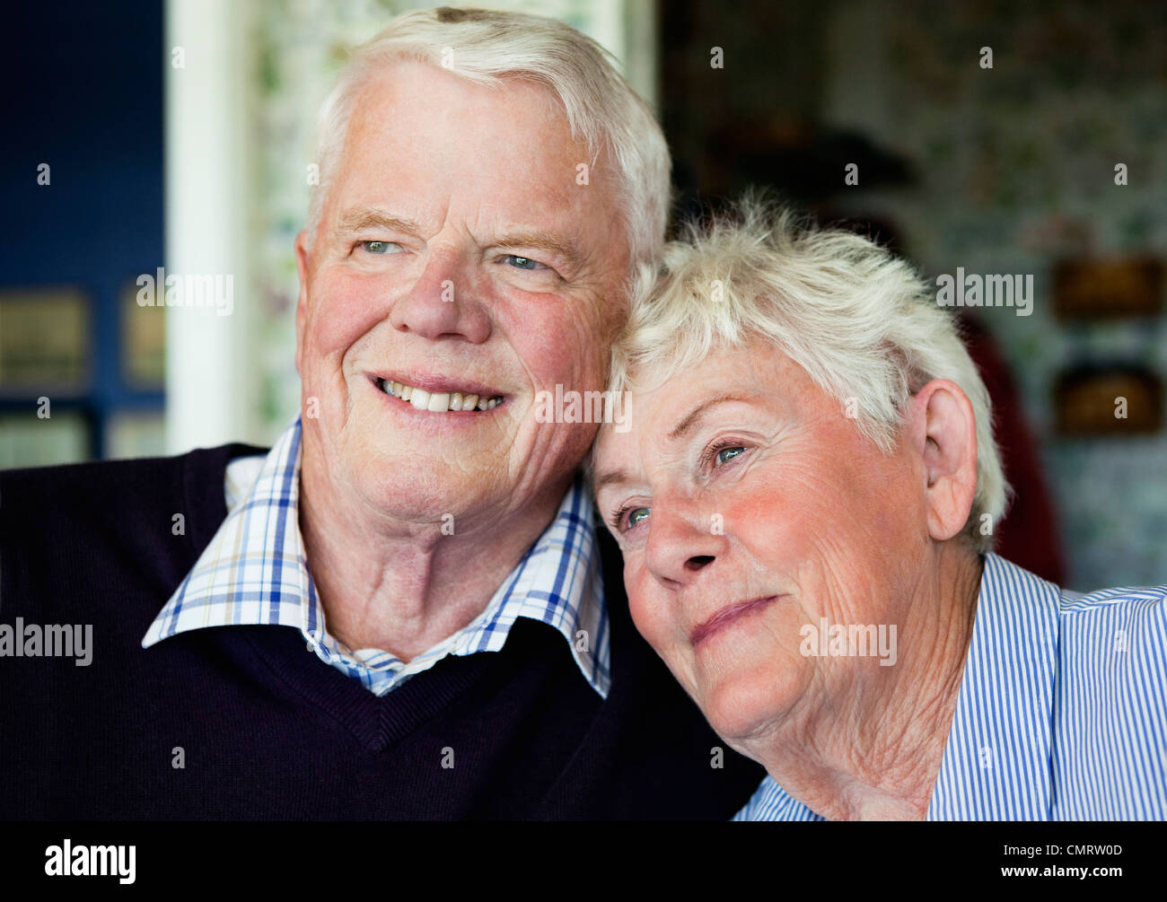 Couple leaning against each other Stock Photo - Alamy