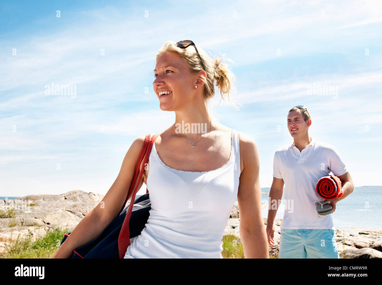 Two people walking on the beach Stock Photo - Alamy