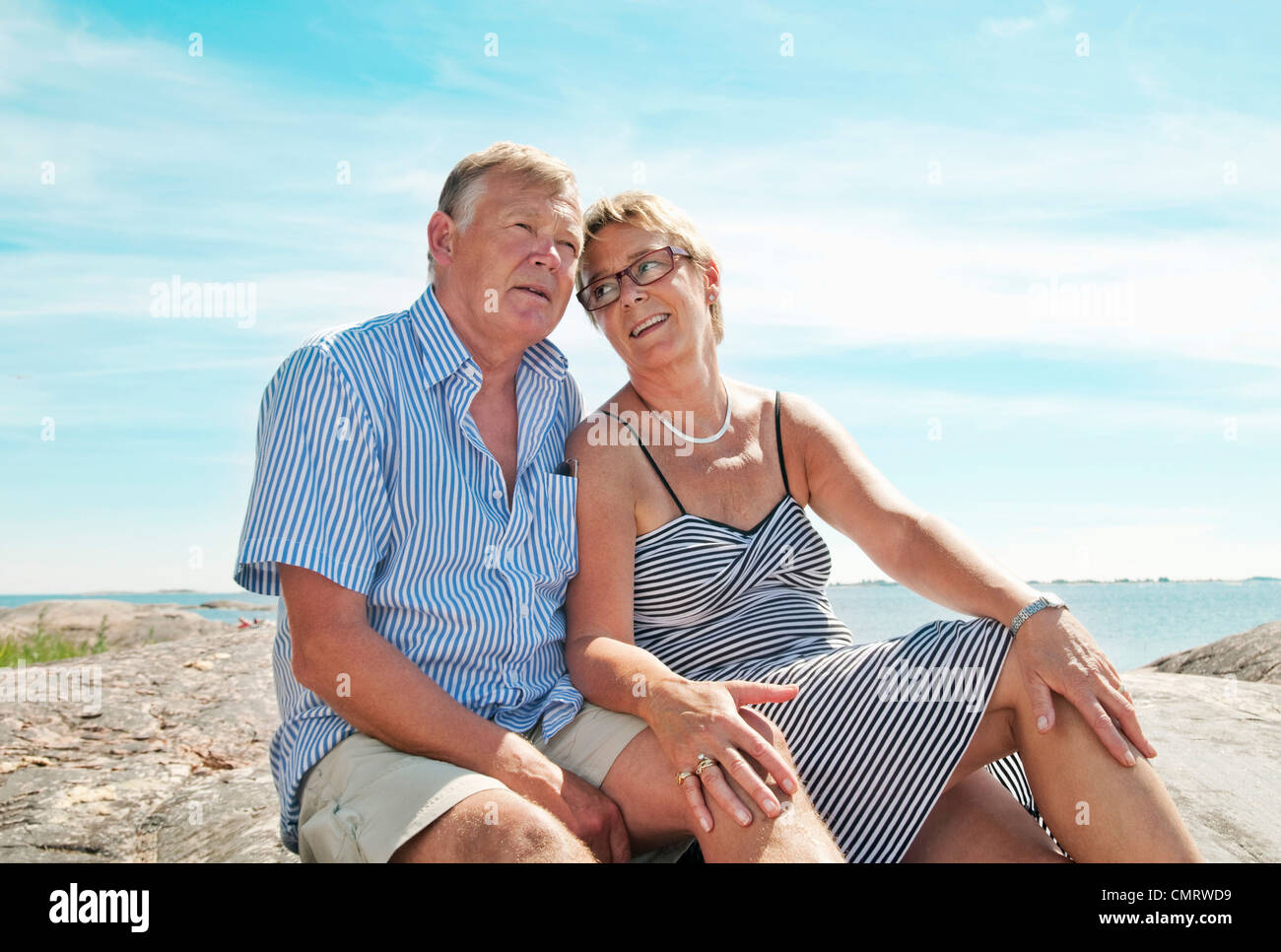 Two elderly people sitting on the beach Stock Photo - Alamy