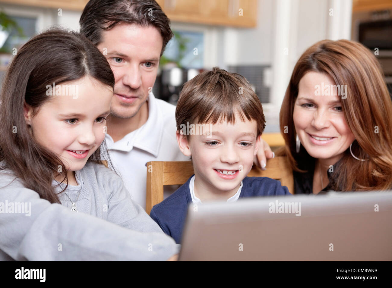 Family in front of computer Stock Photo - Alamy