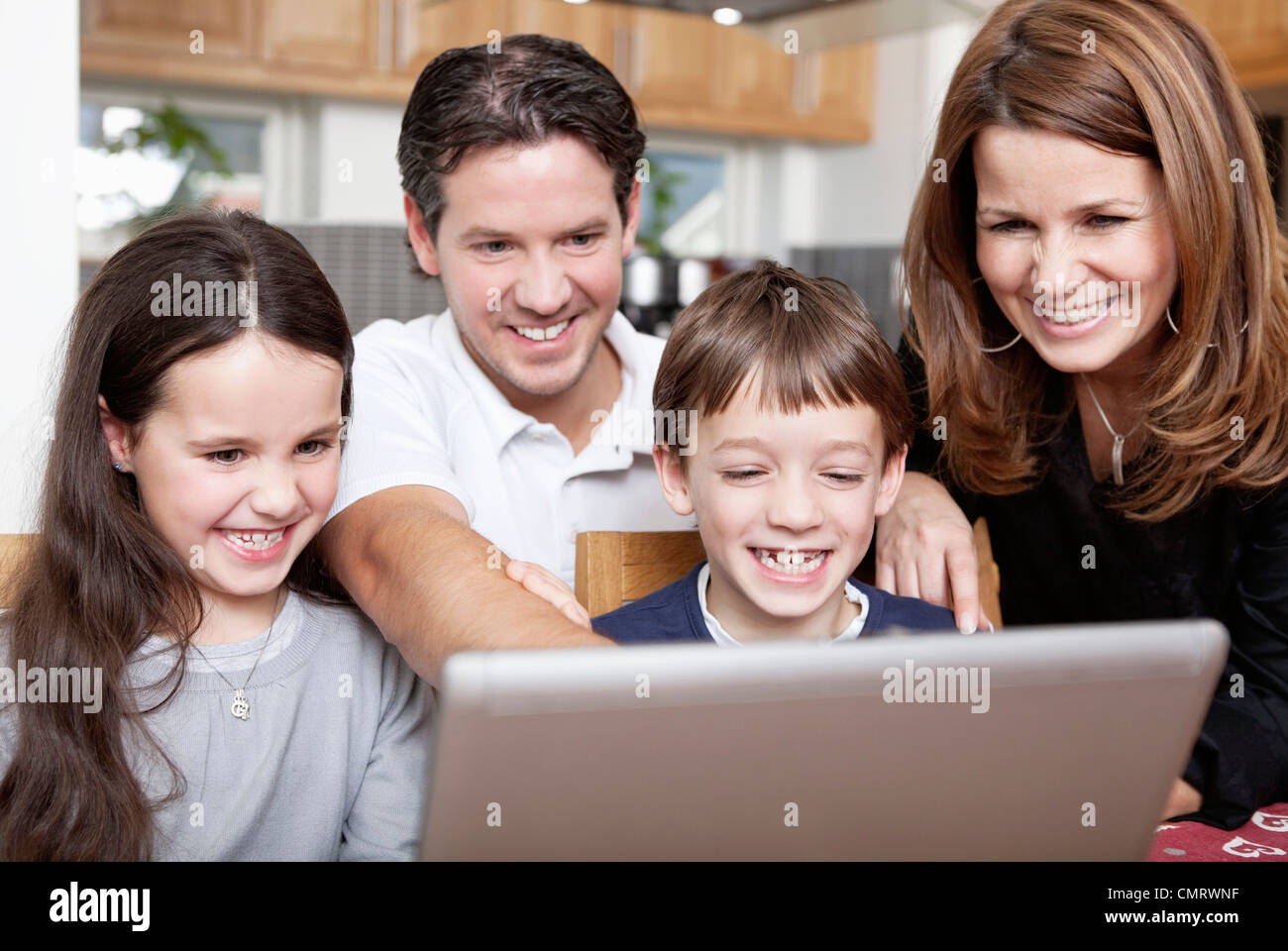 Happy family in front of computer Stock Photo - Alamy