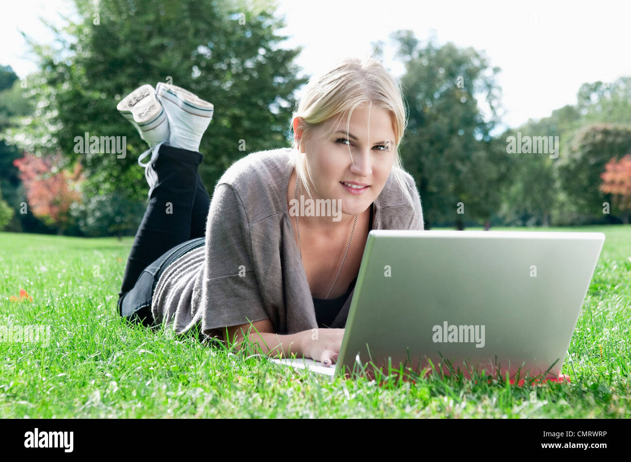 Girl with computer outside Stock Photo - Alamy