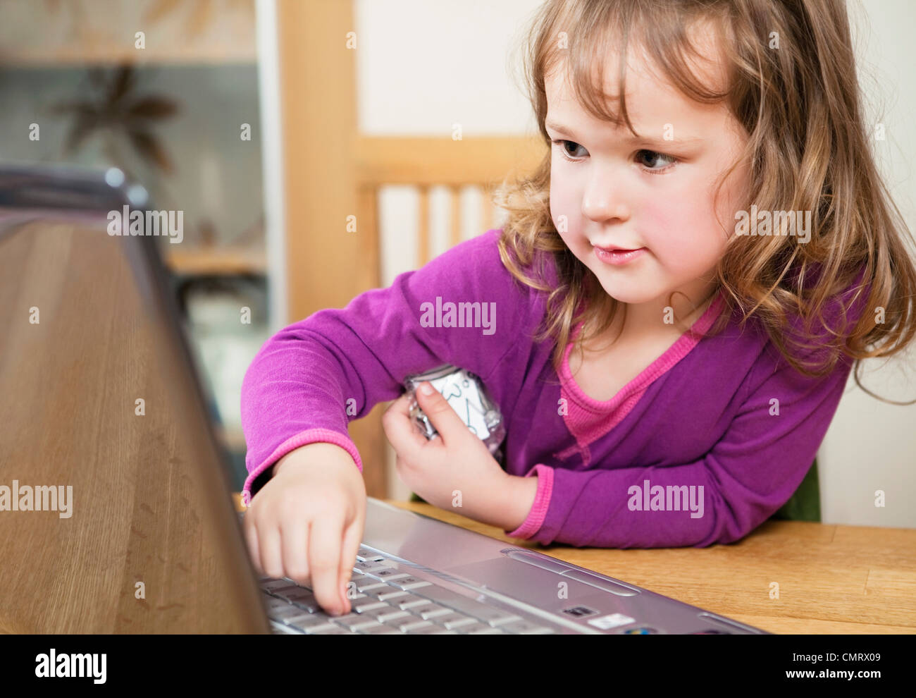 Girl by computer Stock Photo - Alamy