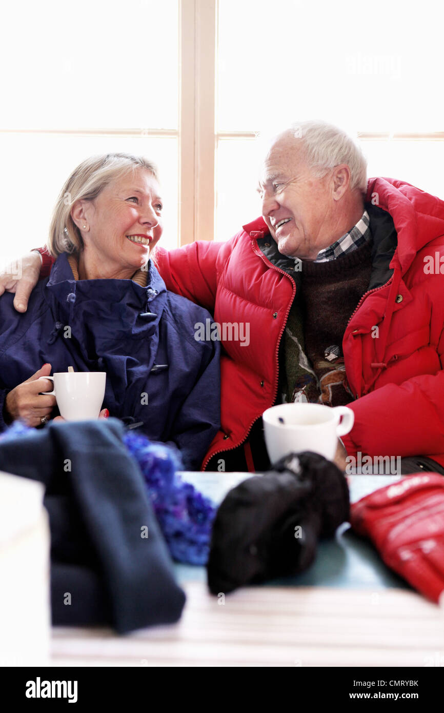 Two people sitting in a sofa Stock Photo - Alamy
