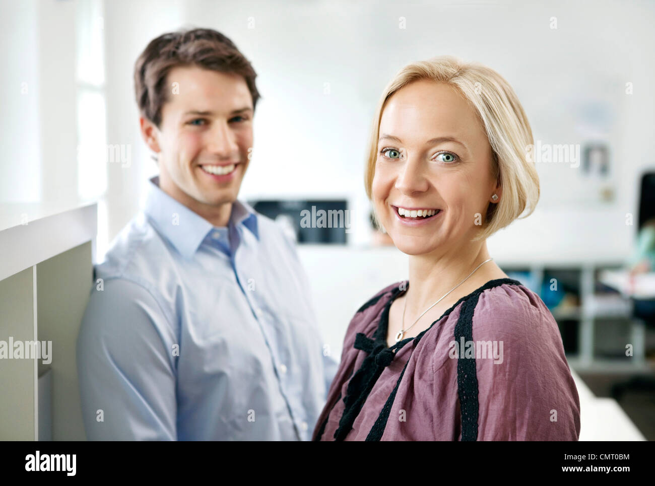 Two happy people at the office Stock Photo - Alamy