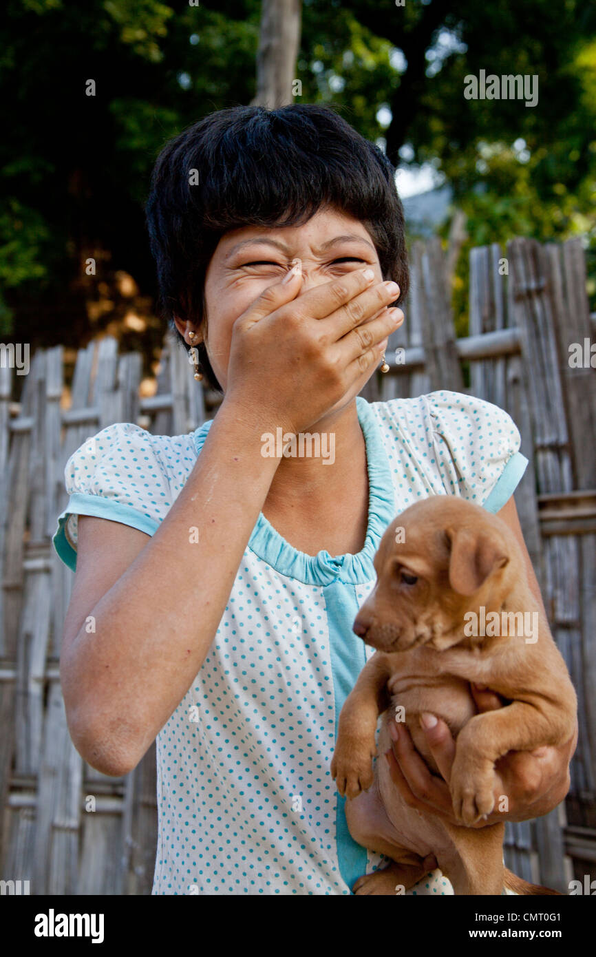 Burmese girl with a puppy, Burma, Myanmar, South East Asia Stock Photo ...