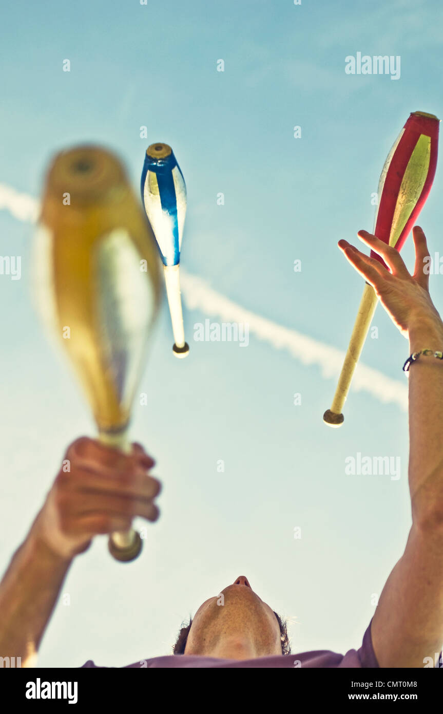 A juggler juggling with clubs Stock Photo - Alamy