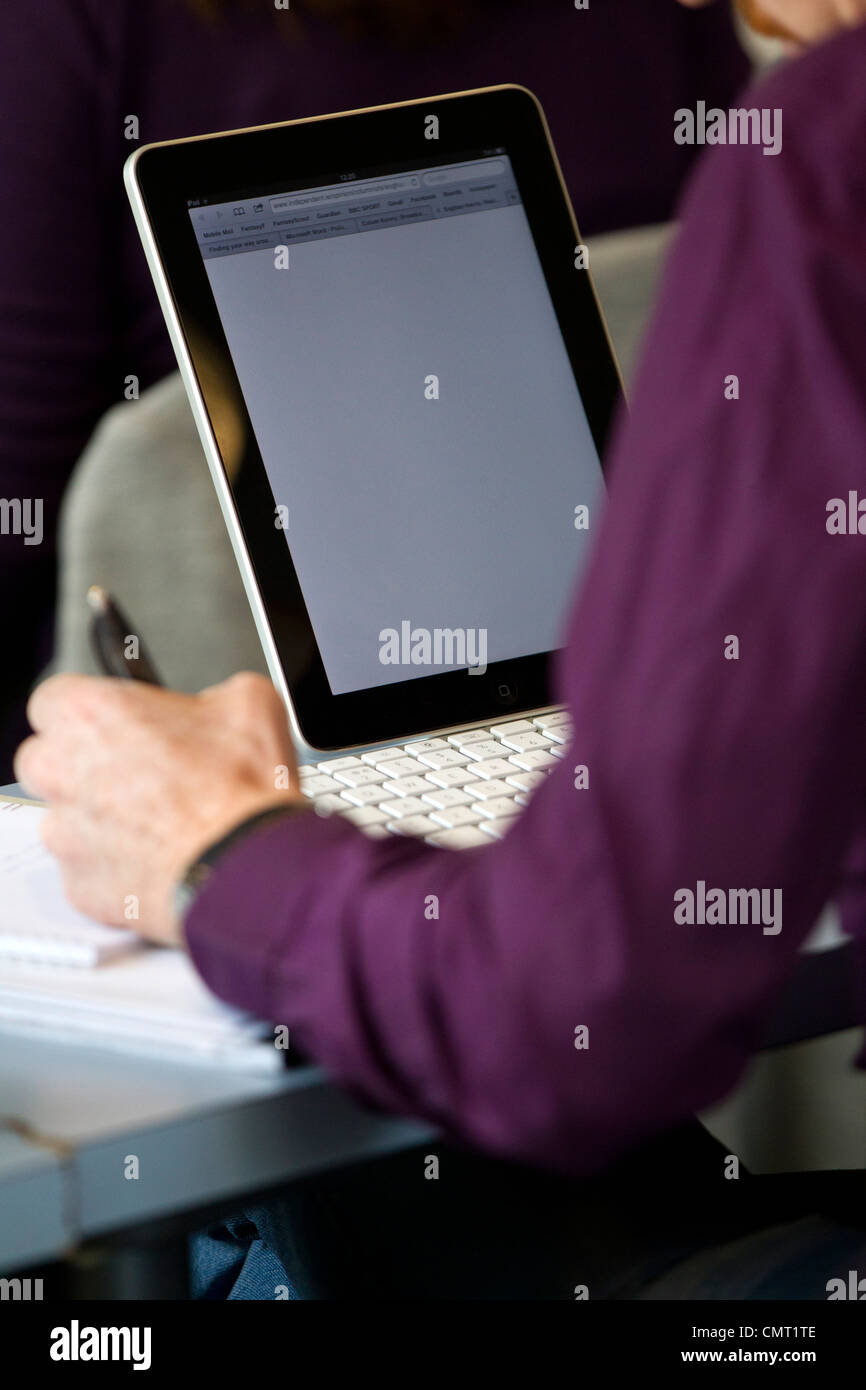 man using apple ipad at conference Stock Photo - Alamy