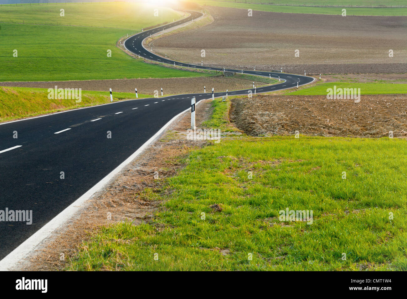 Winding long road in the beautiful countryside Stock Photo - Alamy