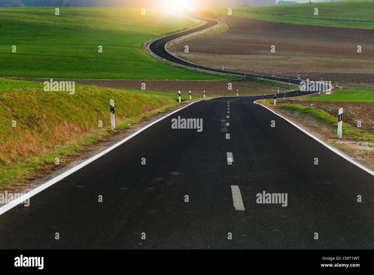 Winding long road in the beautiful countryside Stock Photo - Alamy
