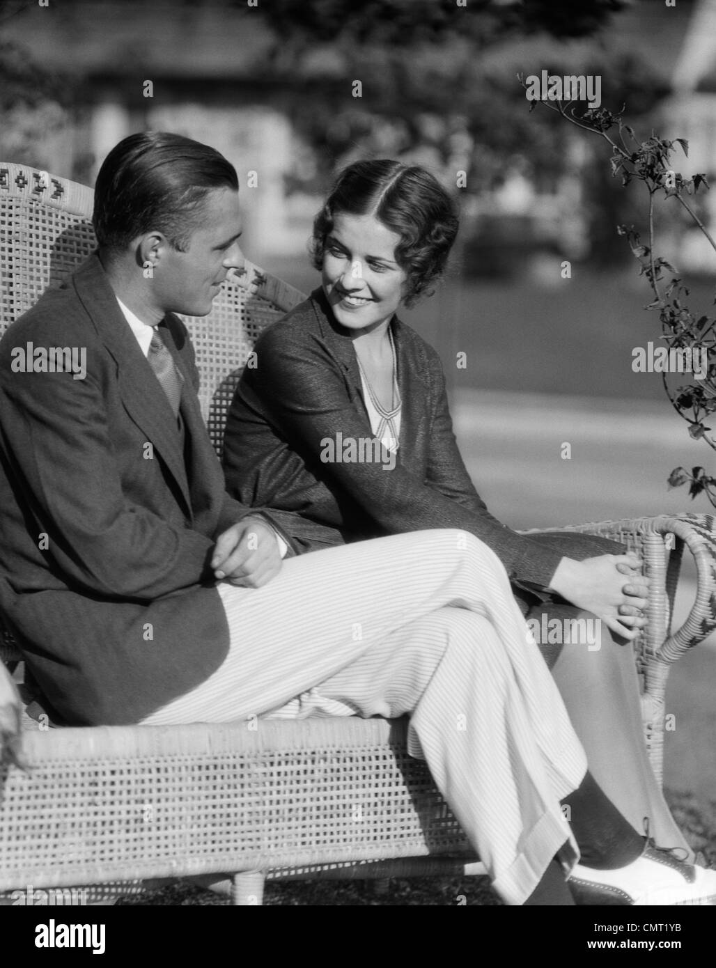 1930s SMILING COUPLE SITTING TOGETHER ON WICKER BENCH HUSBAND WIFE ...