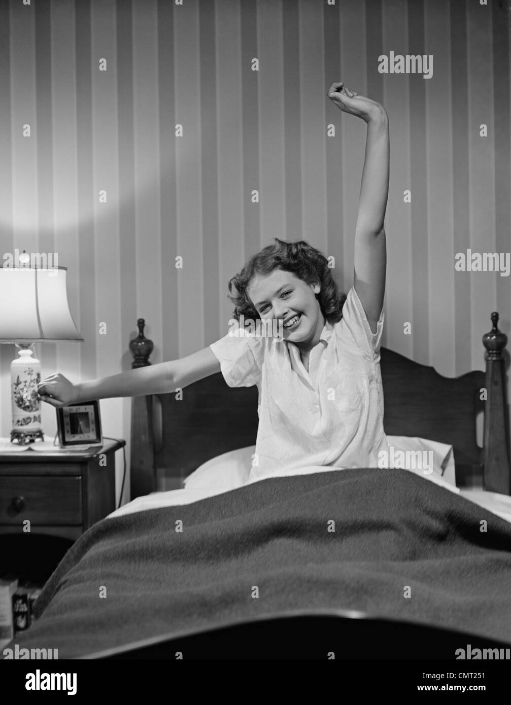 1940s YOUNG WOMAN IN BED STRETCHING WAKING UP Stock Photo - Alamy