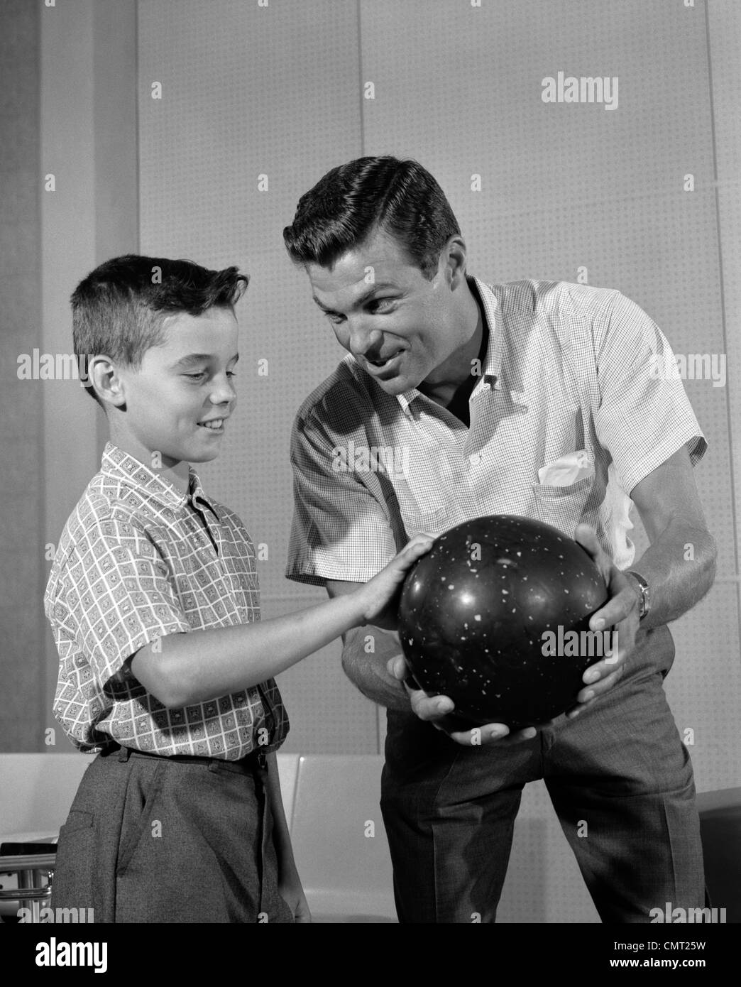1960s FATHER SHOWING SON HOW TO HOLD BOWLING BALL INDOOR Stock Photo ...