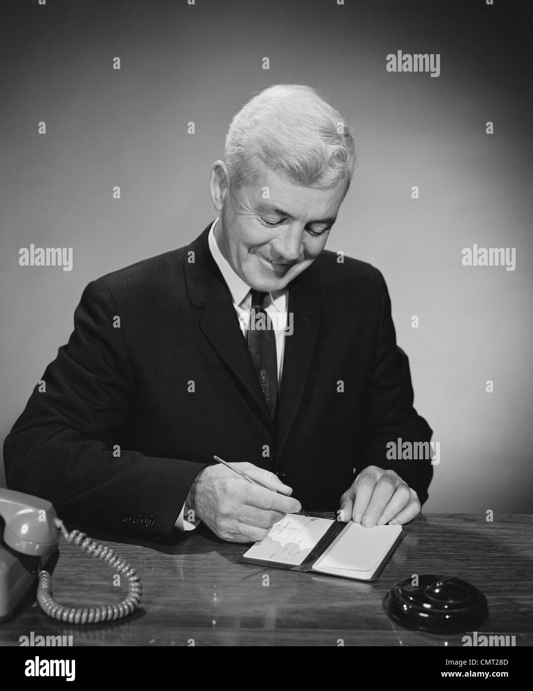 1960s MAN WRITING CHECK FROM CHECKBOOK Stock Photo - Alamy