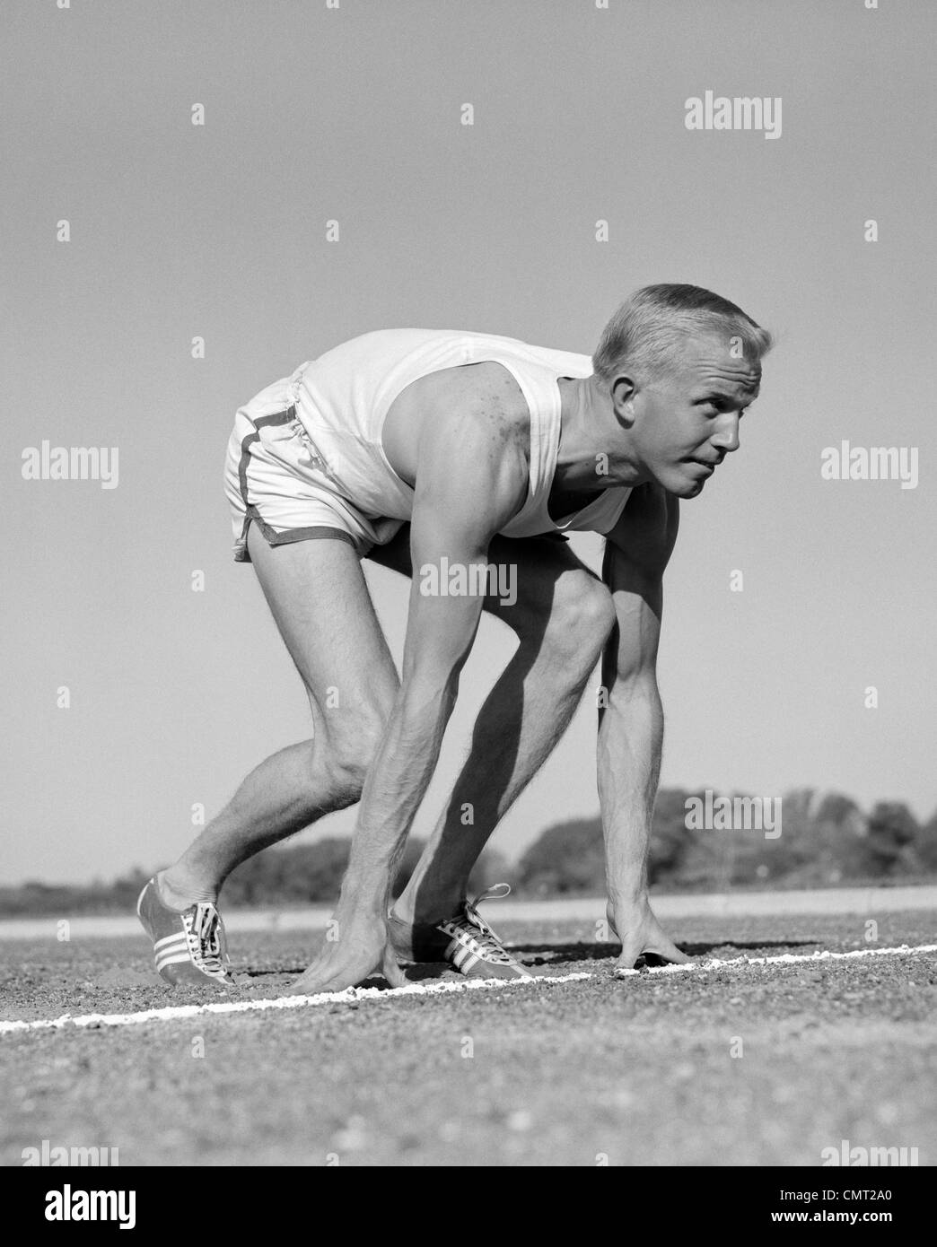 1960s MAN SPRINTER RUNNER AT THE STARTING LINE FOR FOOT RACE OUTDOOR ...