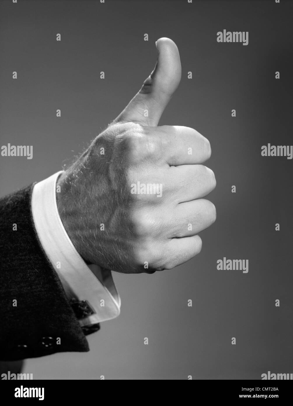 1960s CLOSE-UP OF HAND MAKING THUMBS-UP EXPRESSION SYMBOLIC OF SUCCESS ...