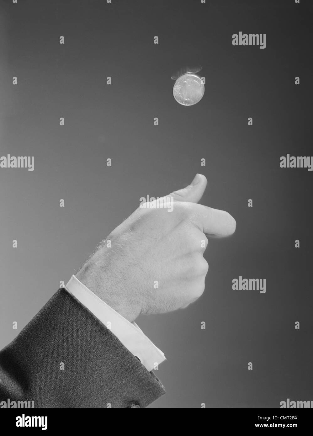 Hand tossing a coin hi-res stock photography and images - Alamy