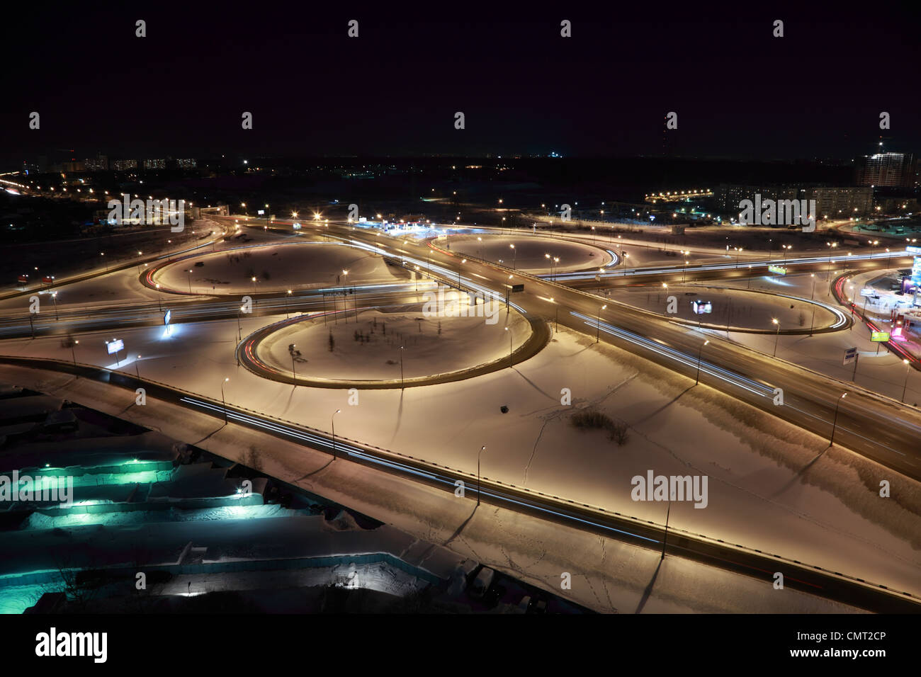 night winter cityscape with big interchange, lighting columns and ...