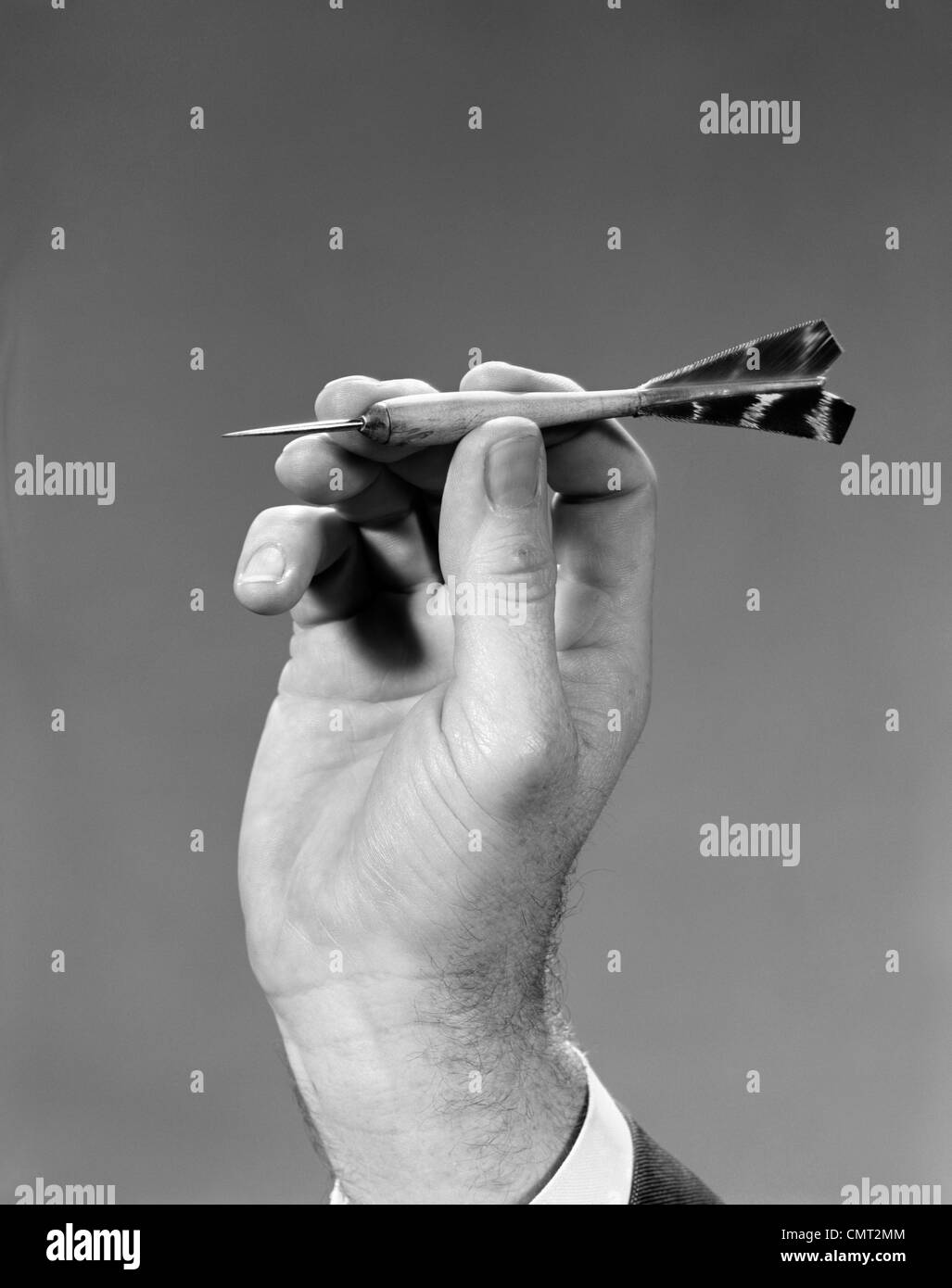 1960s 1970s HAND CLOSE-UP HOLDING ABOUT TO THROW A SHARP POINTED DART ...