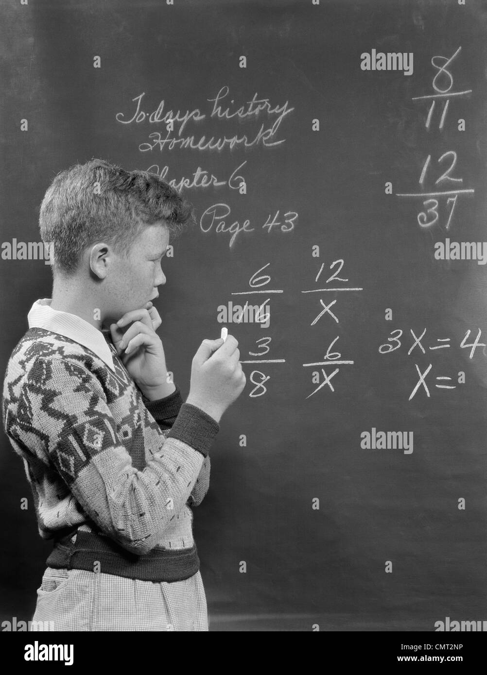 1950s BOY AT BLACKBOARD DOING MATH MULTIPLICATION PROBLEM Stock Photo ...