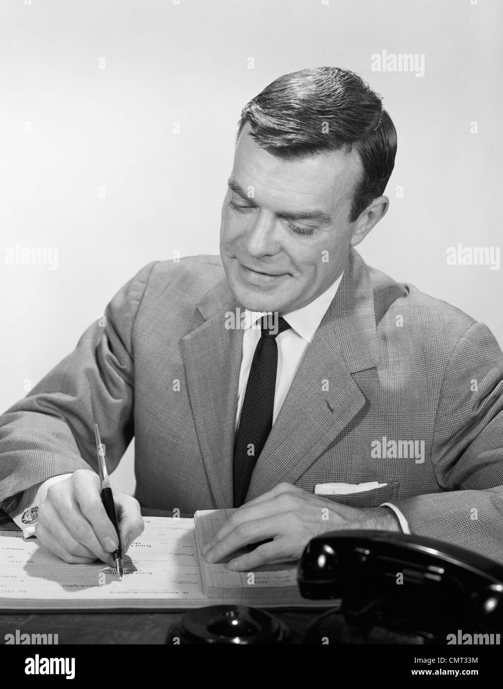 1950s man sitting at desk Black and White Stock Photos & Images - Alamy