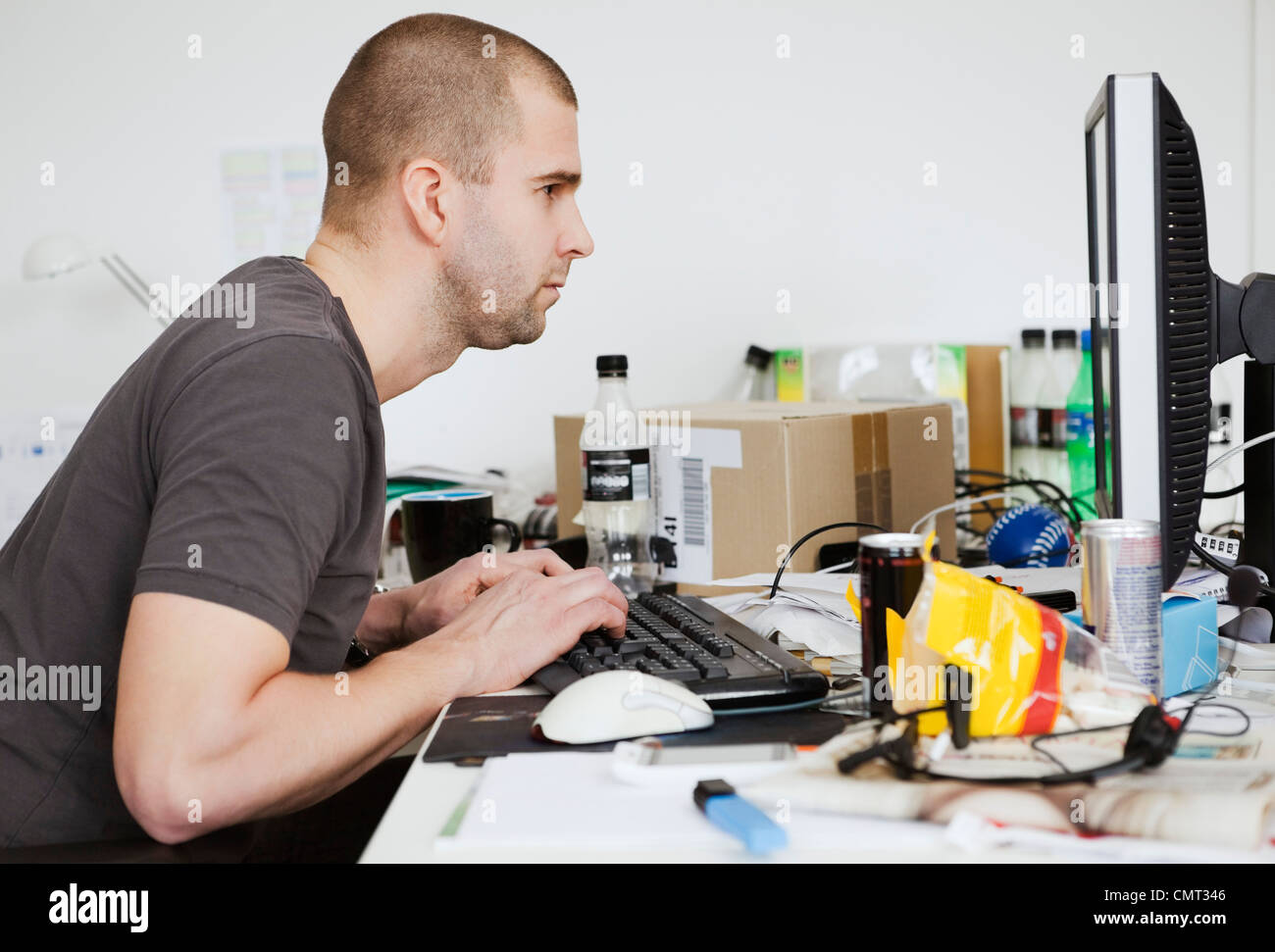 Man sitting concentrated by his computer Stock Photo - Alamy
