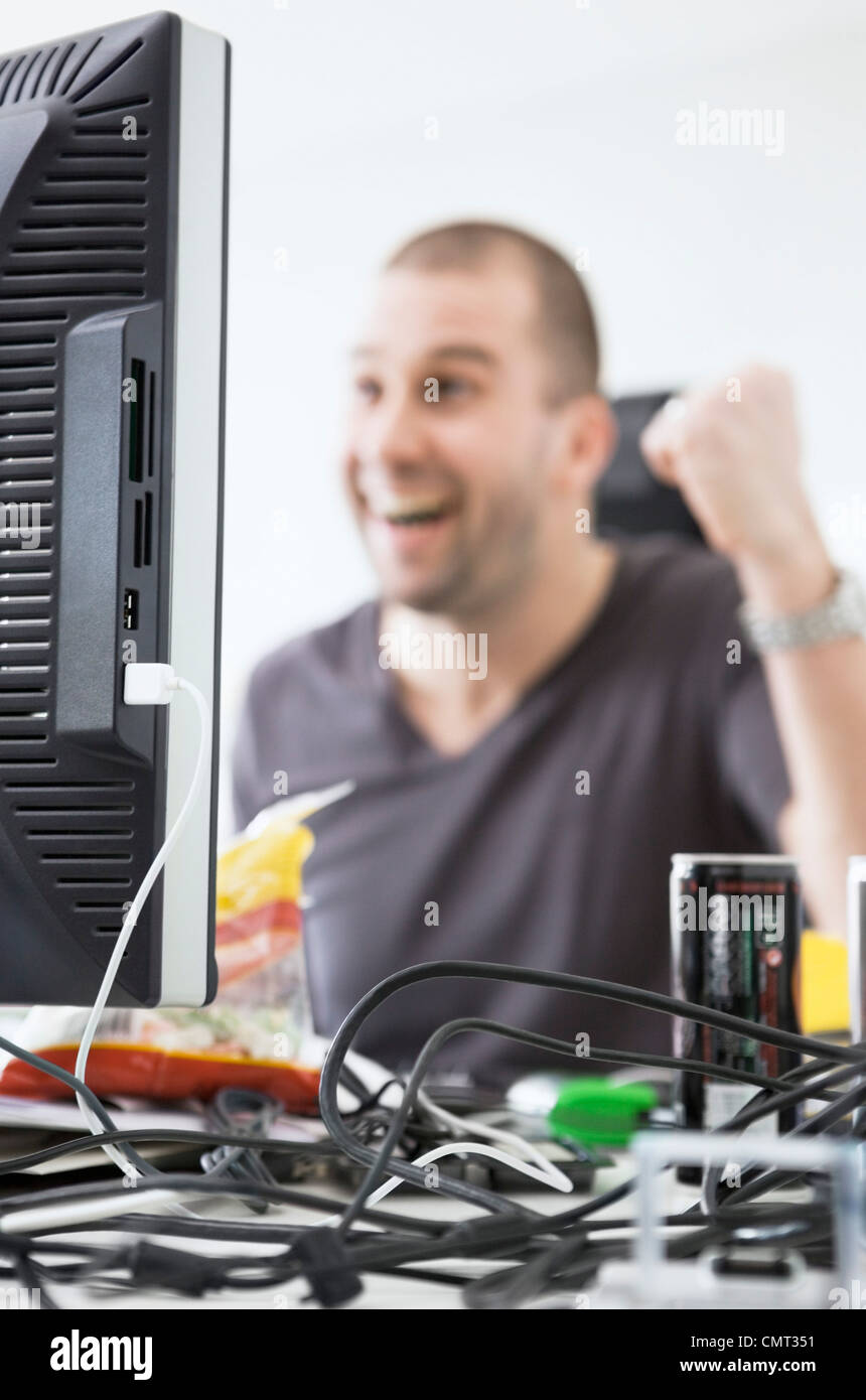 Man cheering behind the computer screen Stock Photo - Alamy