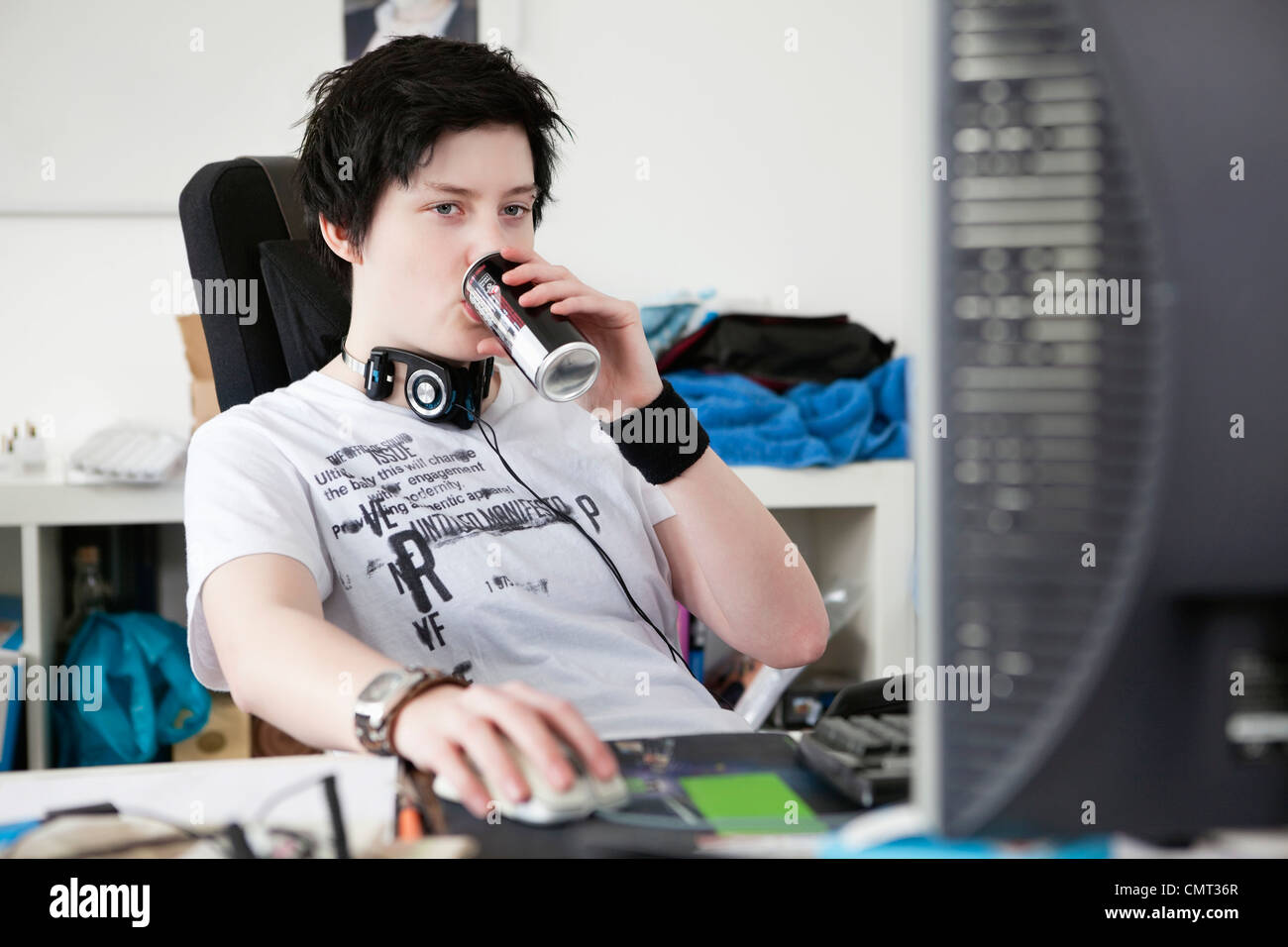 Woman drinking energy drink by the computer Stock Photo - Alamy