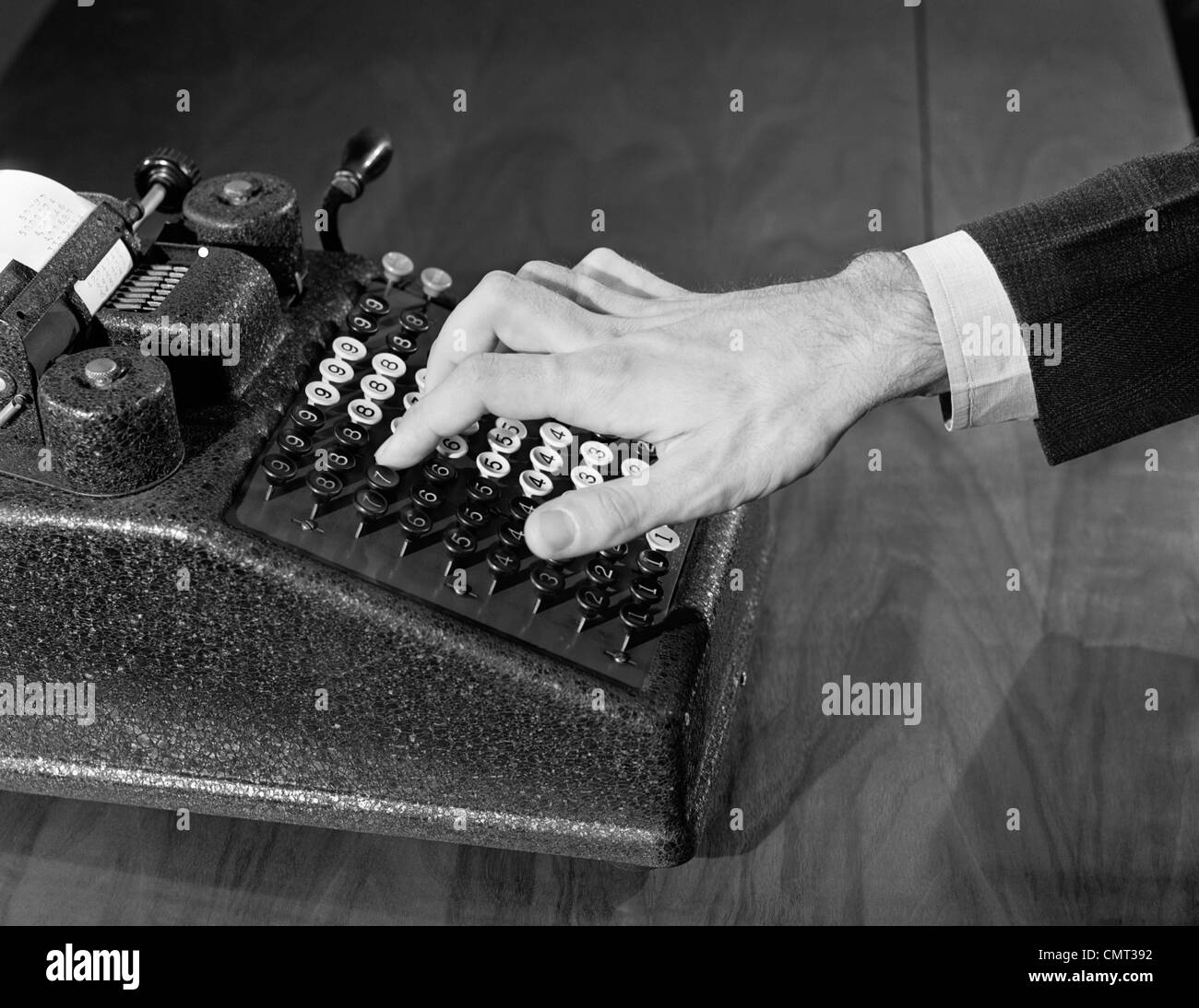 1940s SYMBOLIC MALE HAND ON MANUAL ADDING MACHINE Stock Photo - Alamy