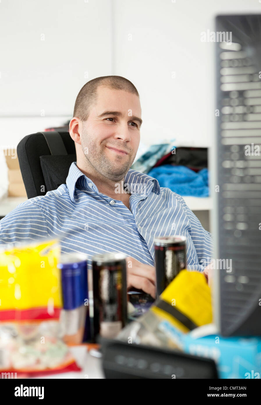 Man working and sitting behind computer Stock Photo - Alamy
