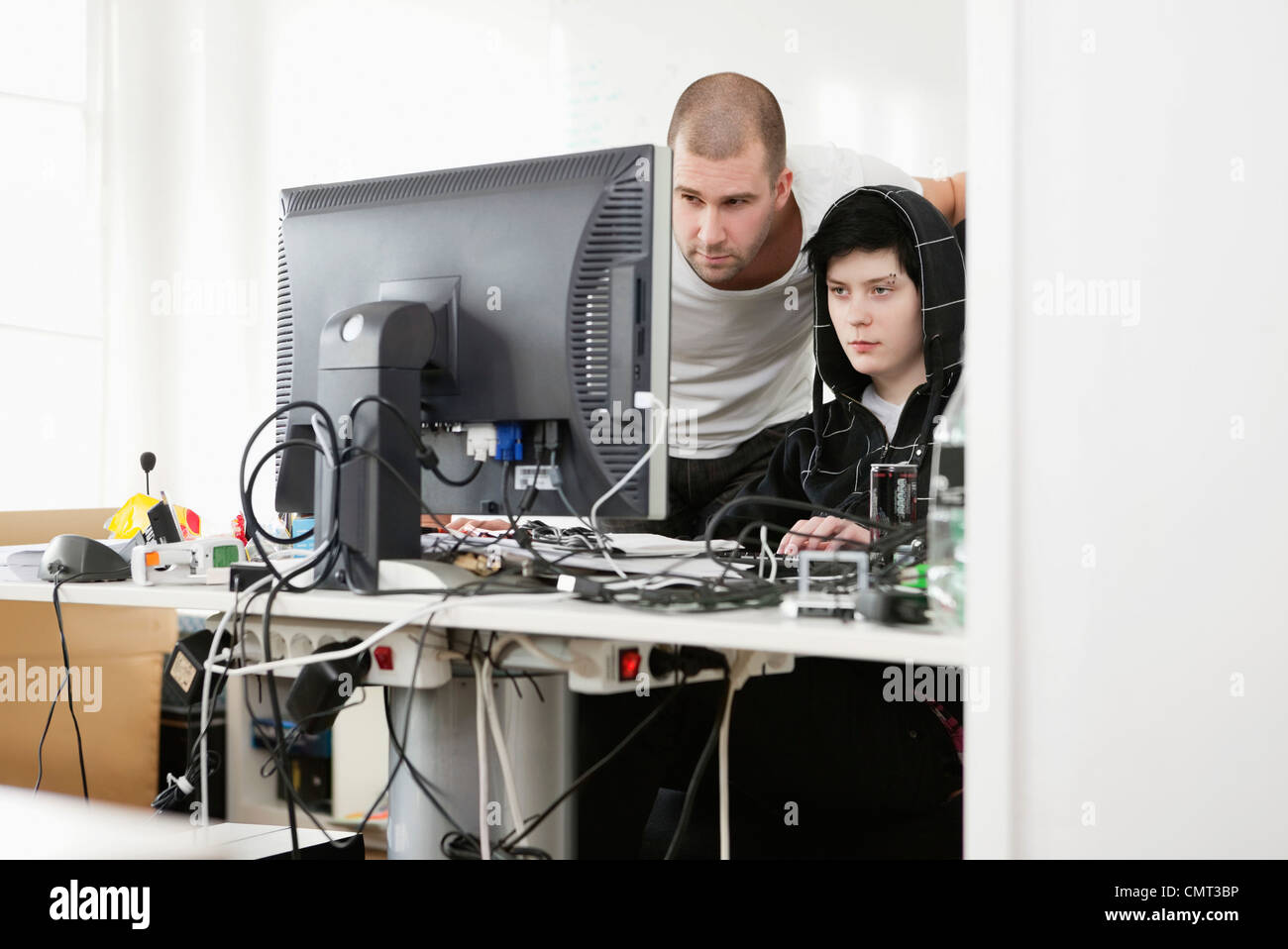 Man and woman working on computer Stock Photo - Alamy