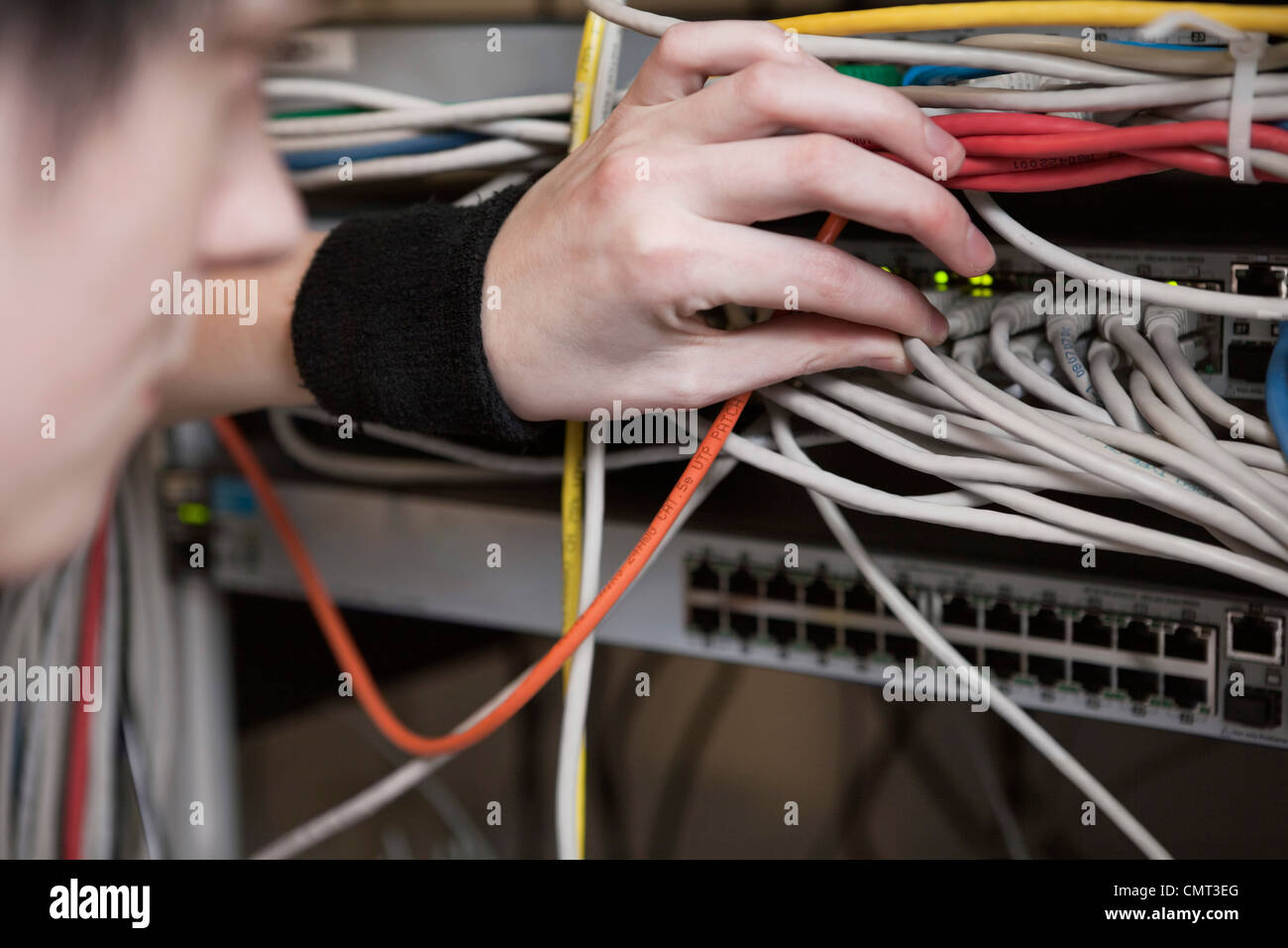 Woman taking out network cables Stock Photo - Alamy