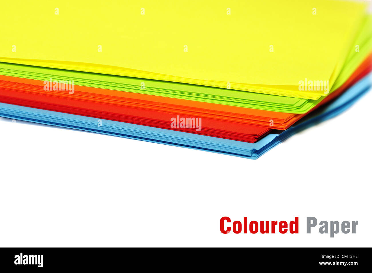Stack of coloured paper over white. Closeup shallow DOF Stock Photo - Alamy