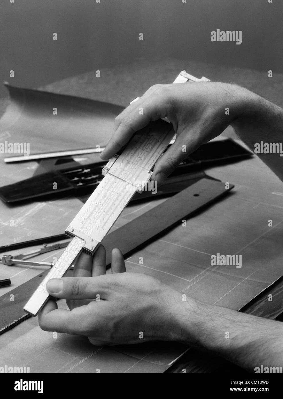 1930s MAN'S HANDS USING SLIDE RULE OVER DRAFTING TABLE Stock Photo - Alamy