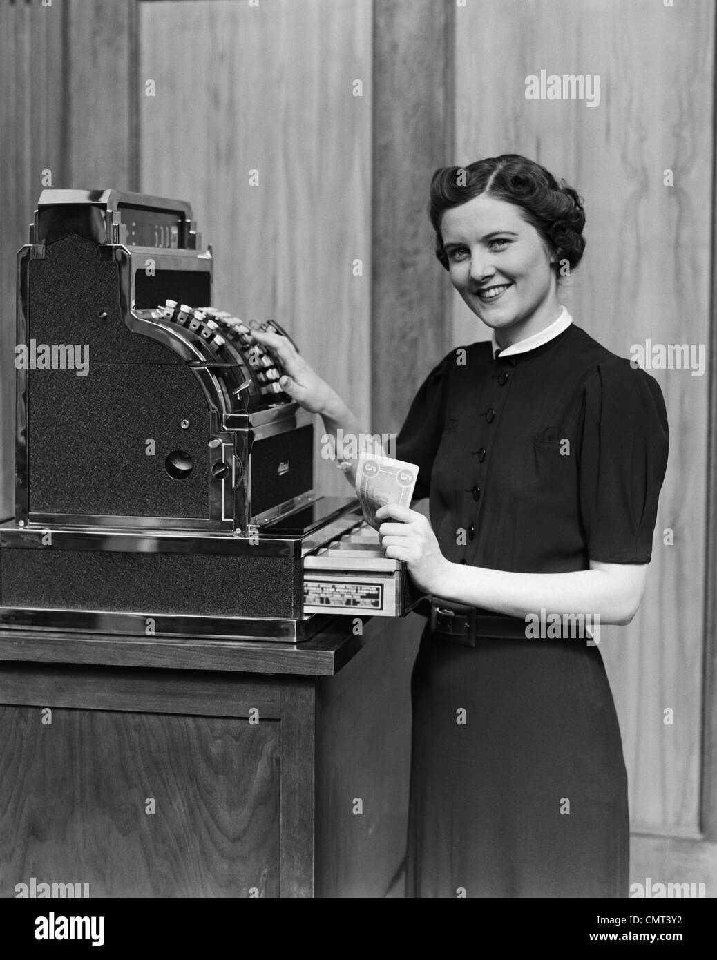 1930s SMILING SALES WOMAN RINGING UP SALE ON CASH REGISTER Stock Photo ...