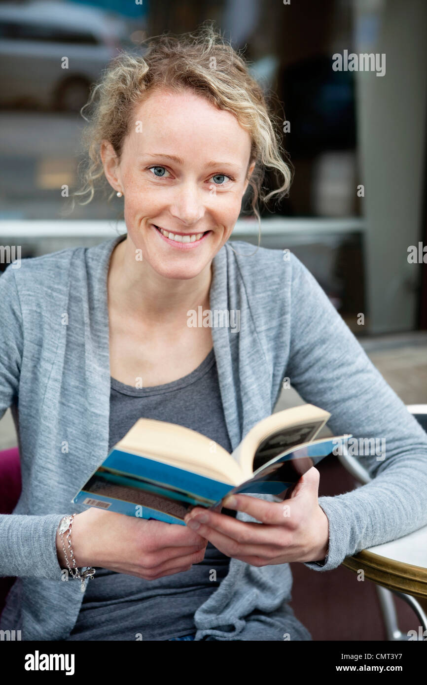 Smiling woman book in hi-res stock photography and images - Alamy