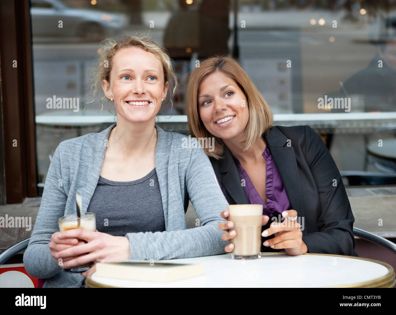 Two women sitting outside coffeehouse Stock Photo - Alamy Two women sitting outside coffeehouse Stock Photo - Alamy