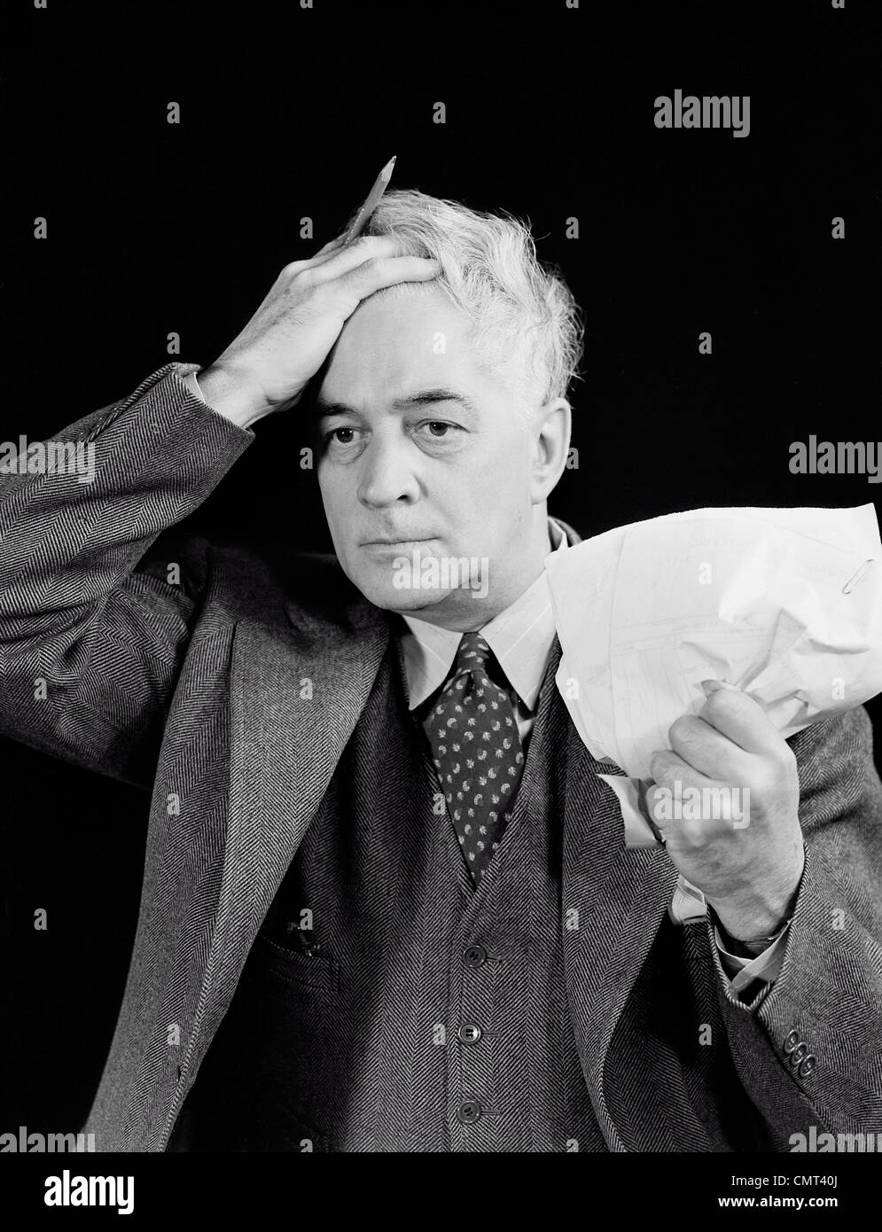 1940s OLDER MAN CRUMPLED PAPER IN ONE HAND HOLDING OTHER HAND TO HEAD ...