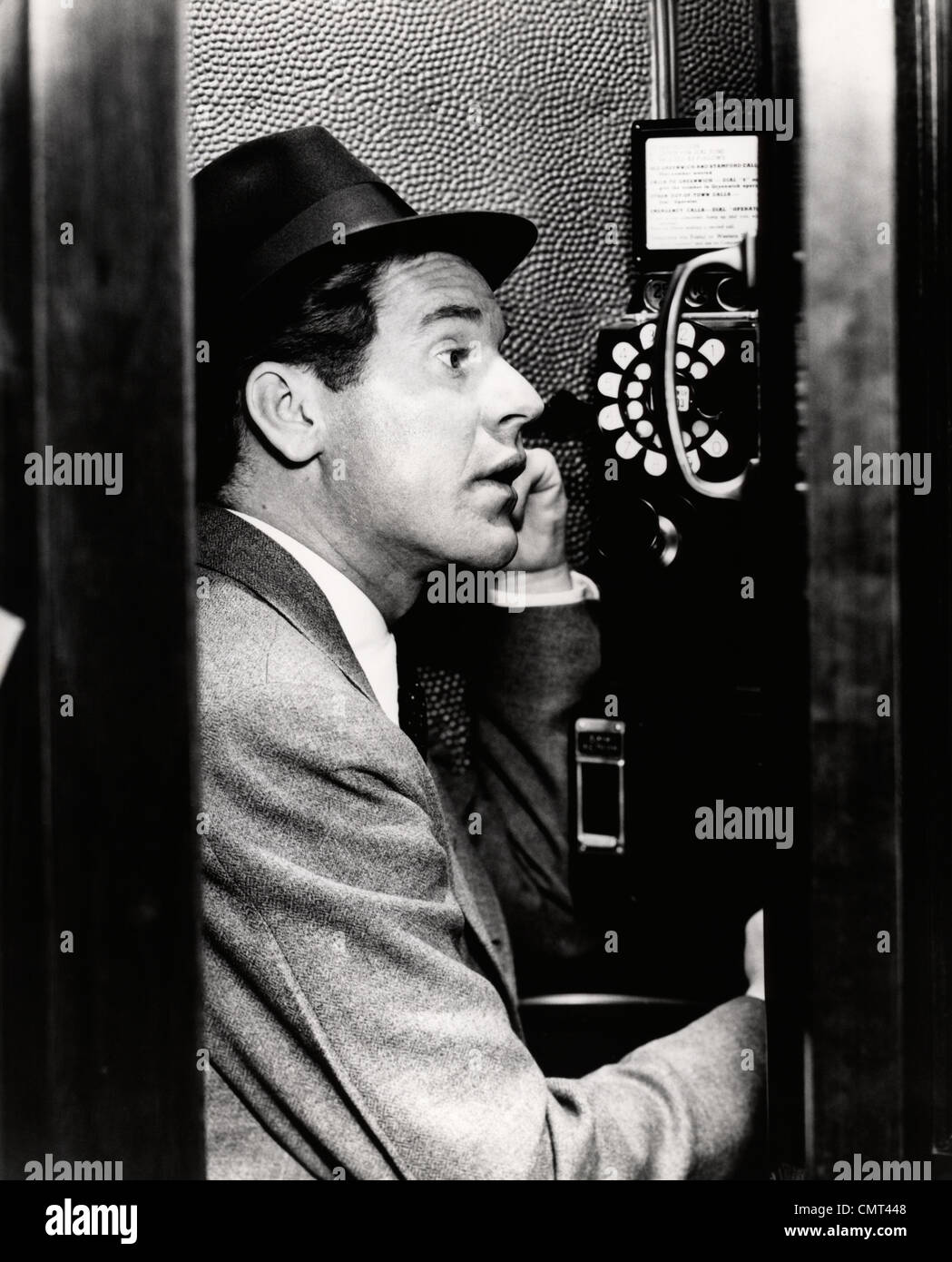 1930s BUSINESSMAN TALKING ON PUBLIC PAY TELEPHONE IN PHONE BOOTH Stock ...