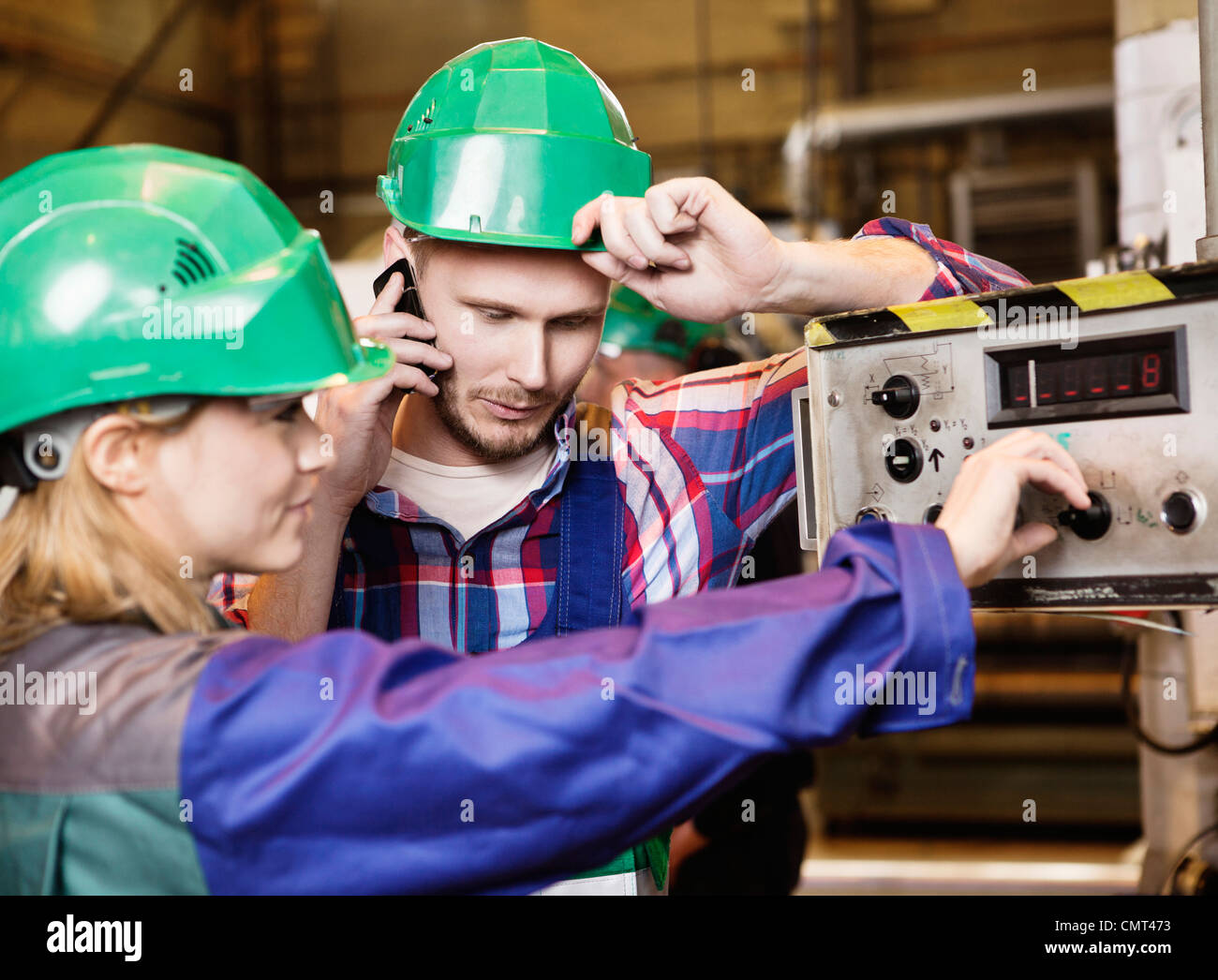 Man and woman working in a factory Stock Photo - Alamy