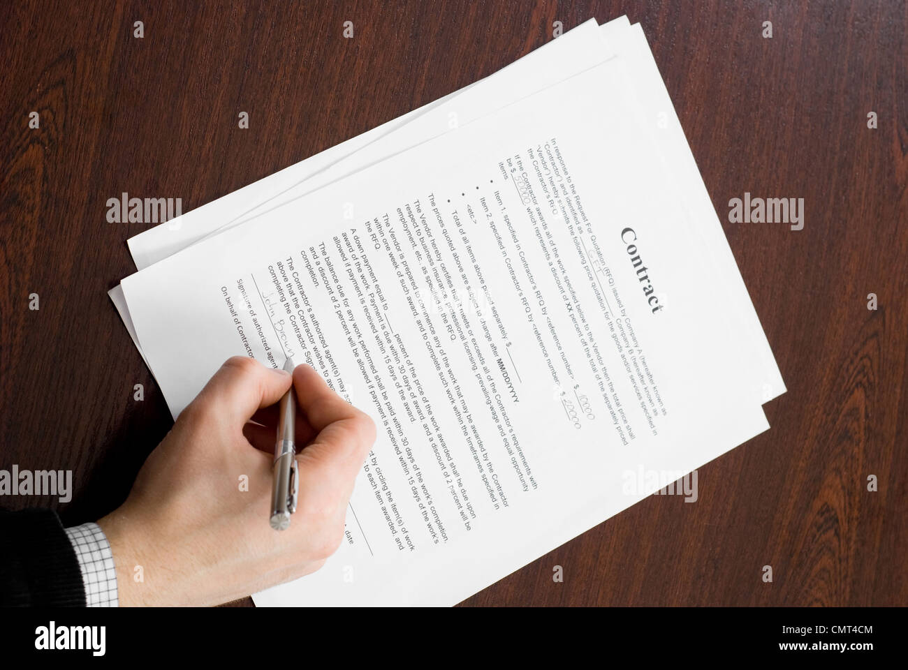 Business man filling out contract with one hand Stock Photo - Alamy