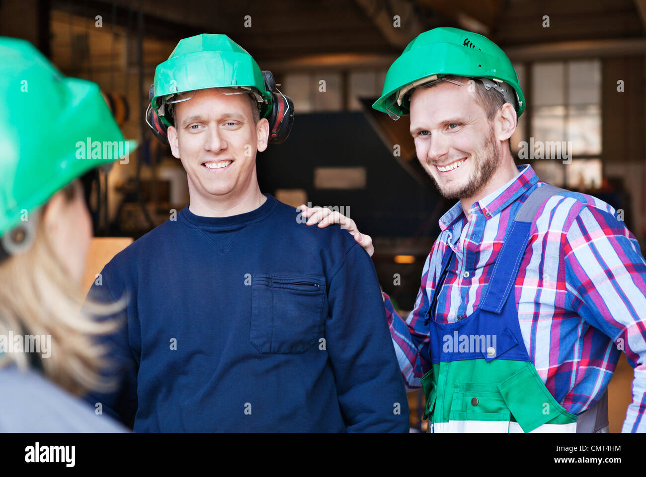Three smiling industrial workers Stock Photo - Alamy
