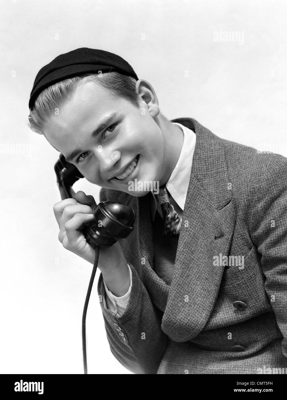 1940s COLLEGE AGE MAN IN SUIT AND FRESHMAN DINK HAT SMILING TALKING ON ...