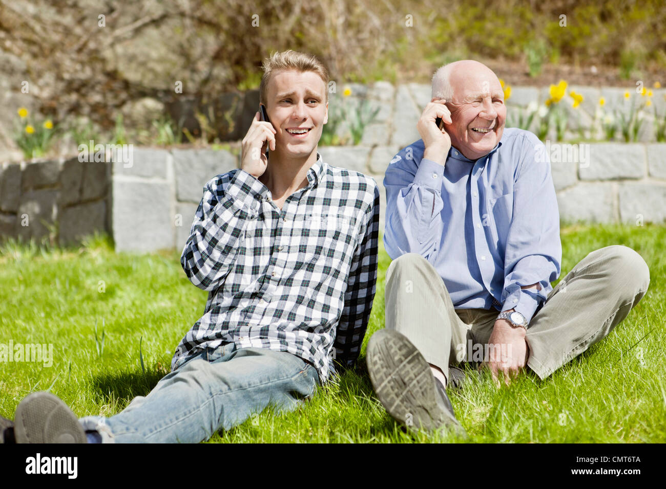 Happy grandson and grandfather talking on the phone Stock Photo - Alamy