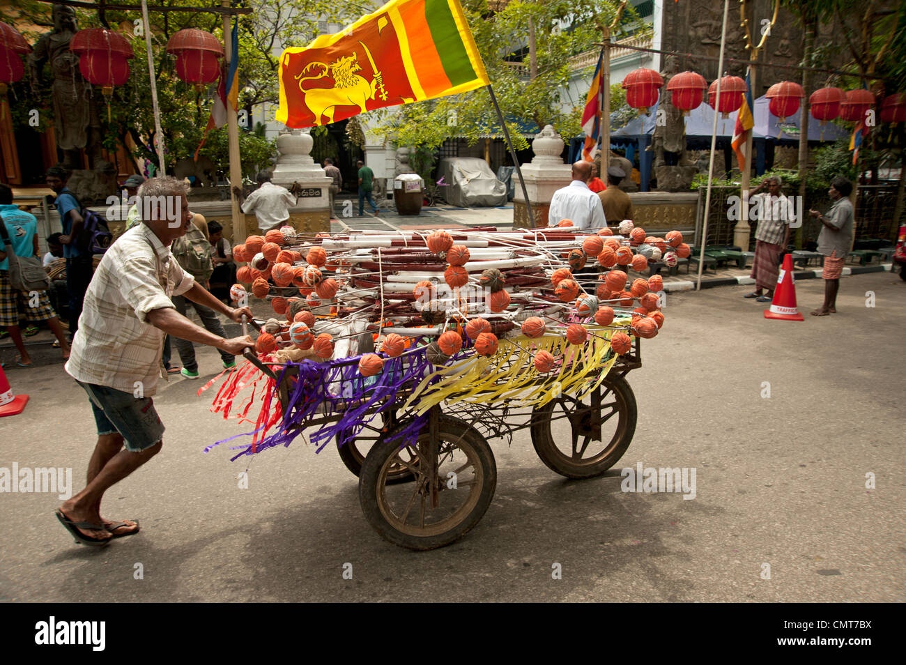 Man pushing a cart laden with festival bunting Colombo Sri Lanka Stock ...